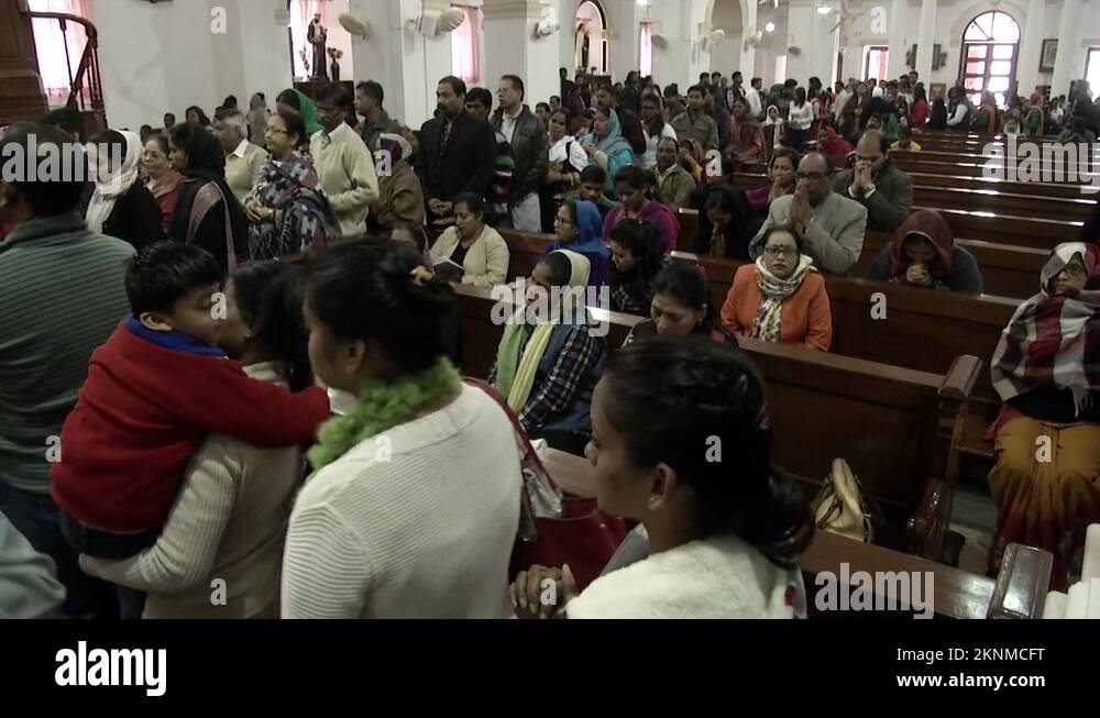 Indian Christian crowded mass church, devotees taking the Holy Host ...