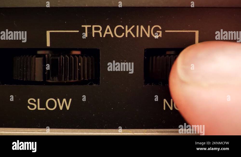 Extreme close up of a button on a vintage VCR adjusting the Tracking ...