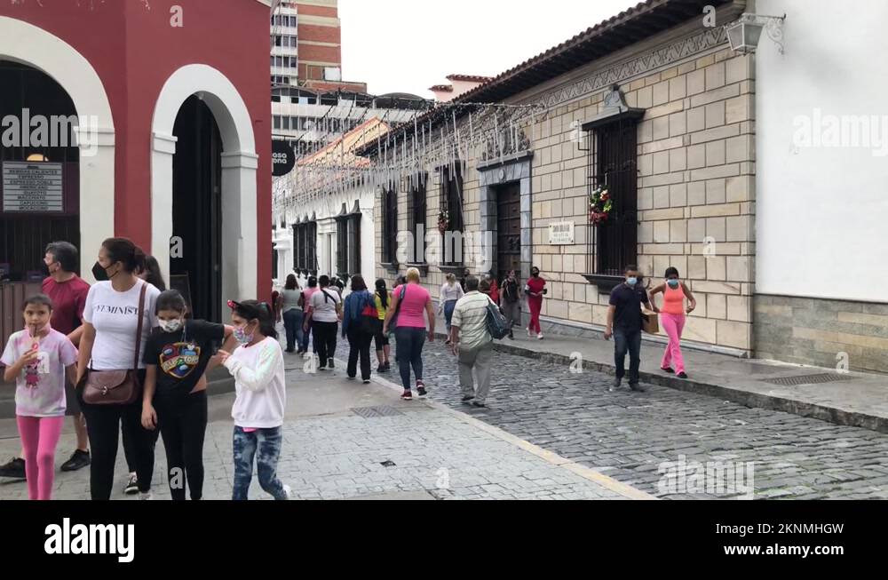 People walking along historic centre streets in downtown Caracas city ...