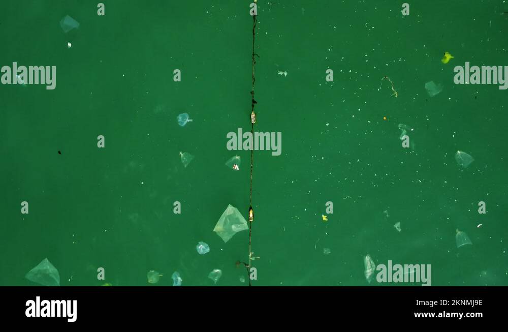 Fishing net in polluted ocean - plastic waste floating around; aerial ...