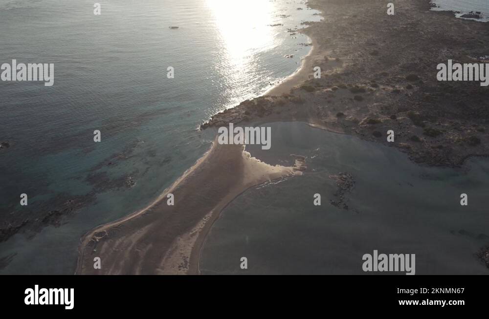 Sunbeam on Elafonissi beach, Crete Island. Reefs, sand and turquoise ...