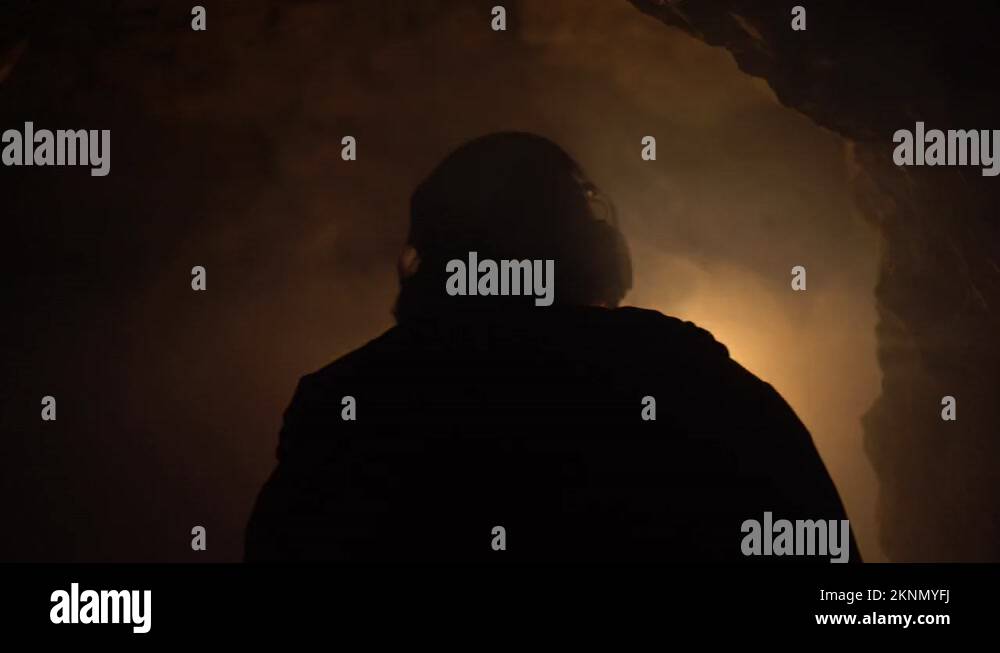 adventurer exploring a dark cave with a torch Stock Video Footage - Alamy