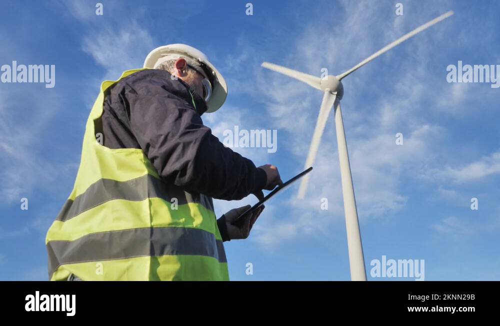wind technician worker using tablet wind turbine power plant background ...