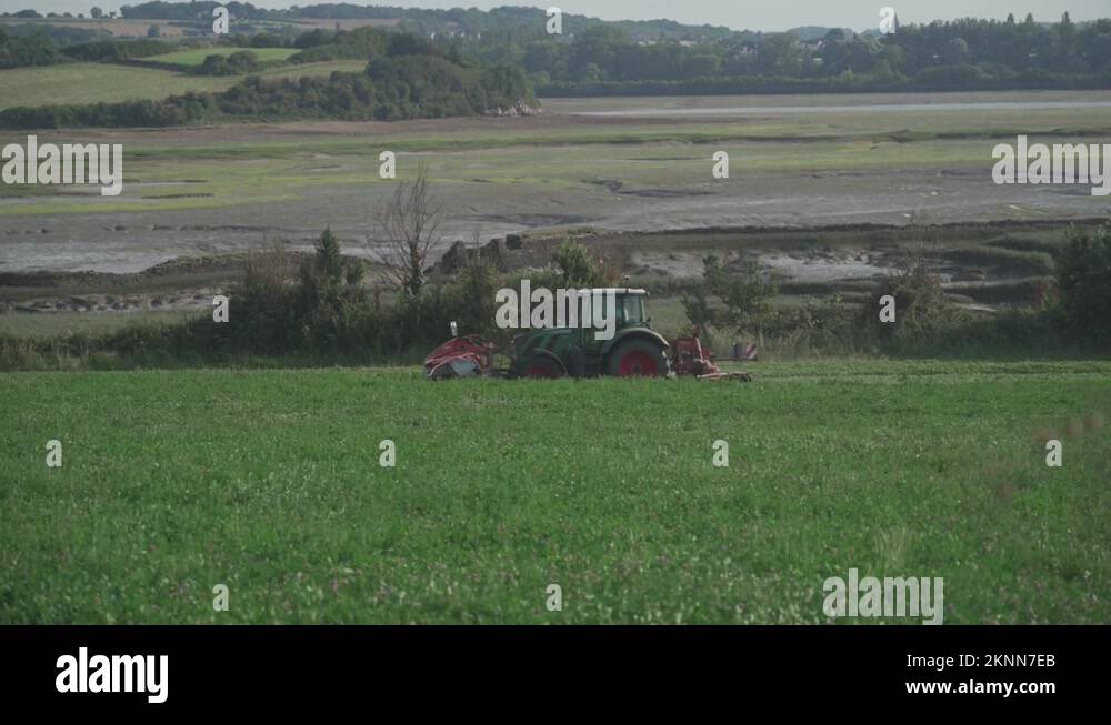 Tractor sowing crops on farm field in the north of france. Agricultural ...