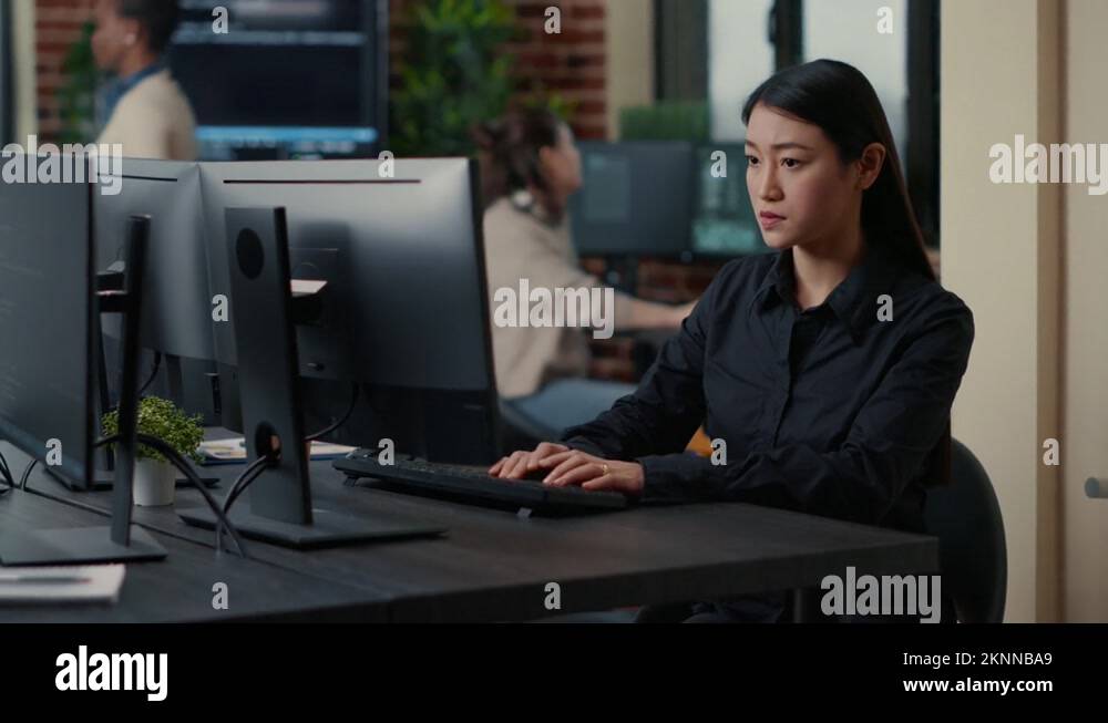 Asian software developer focused on writing code encounters unexpected ... Asian software developer focused on writing code encounters unexpected ...