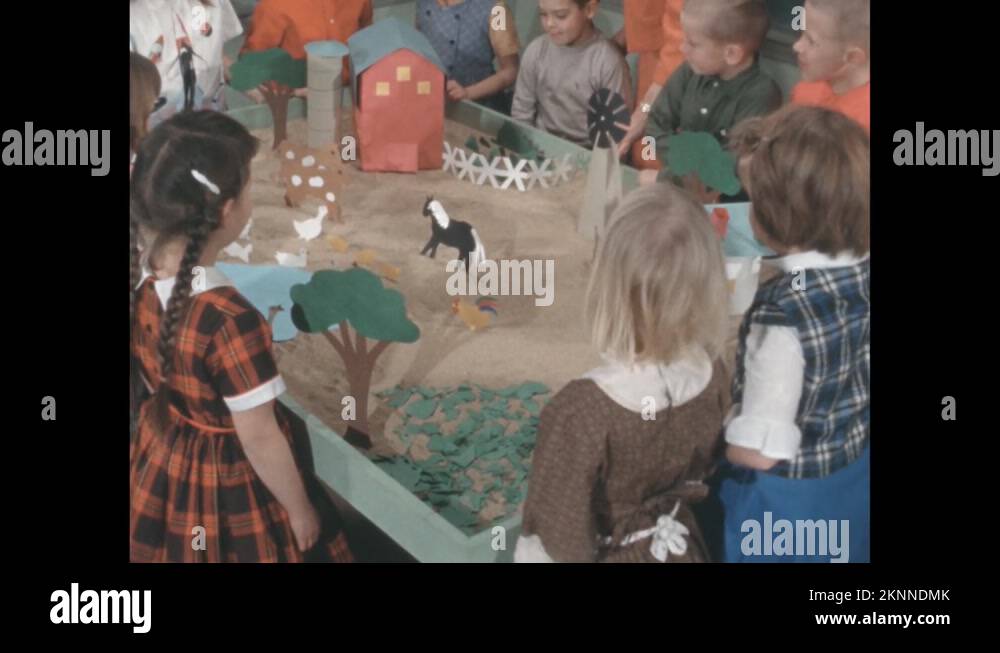1960s: Children gather around a farm scene made with paper cutouts on a ...