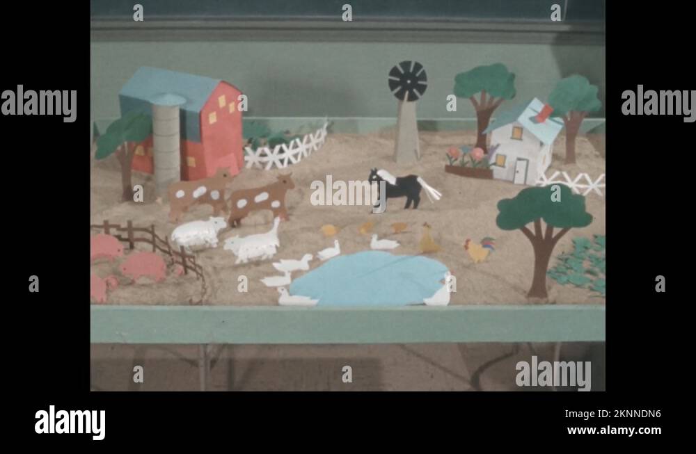1960s: A farm scene made with paper cutouts on a sand table. Slate ...