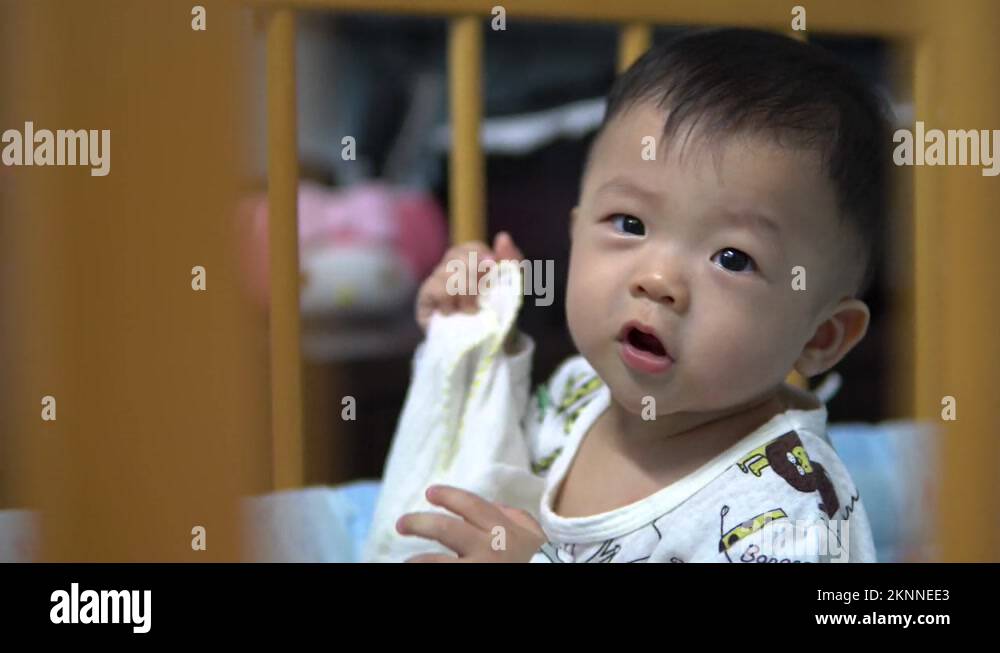portrait footage of 10 month old Asian Chinese baby boy looks and move ...