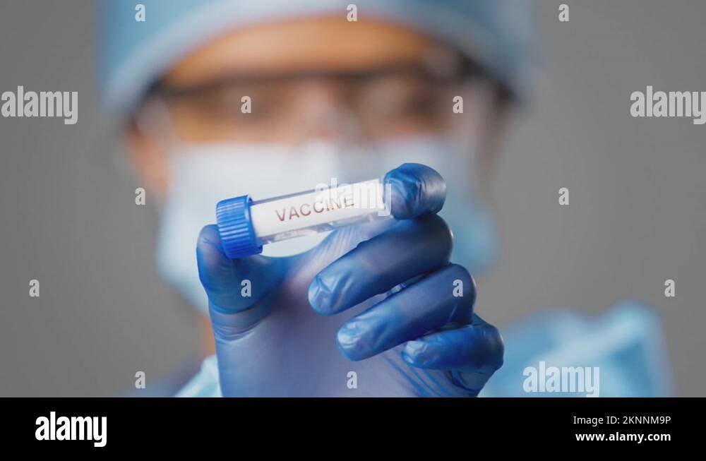 Close Up Of Female Lab Research Worker Wearing PPE Holding Test Tube ...
