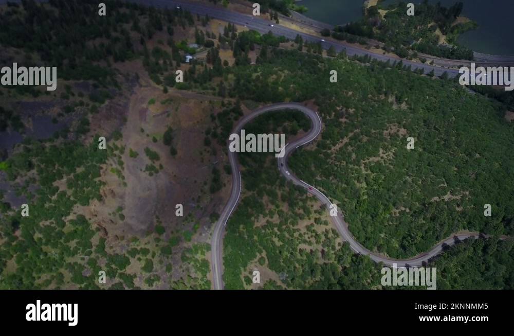 Drone Pan Down overhead of Windy Road with Cars Turning the hairpin ...