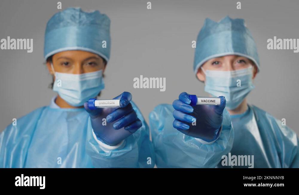 Studio Shot Of Female Lab Research Workers In PPE Holding Test Tubes ...