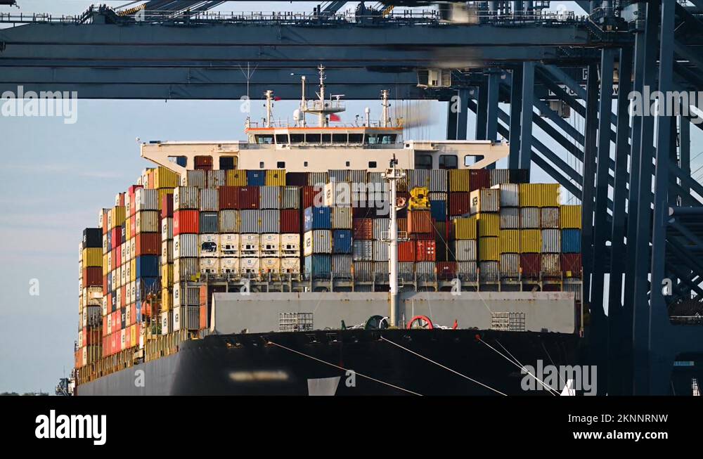 Container ship loading and unloading in deep sea port, telephoto view ...