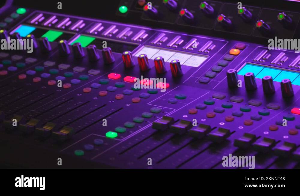 Modern digital mixing console with faders, control buttons and screen ...