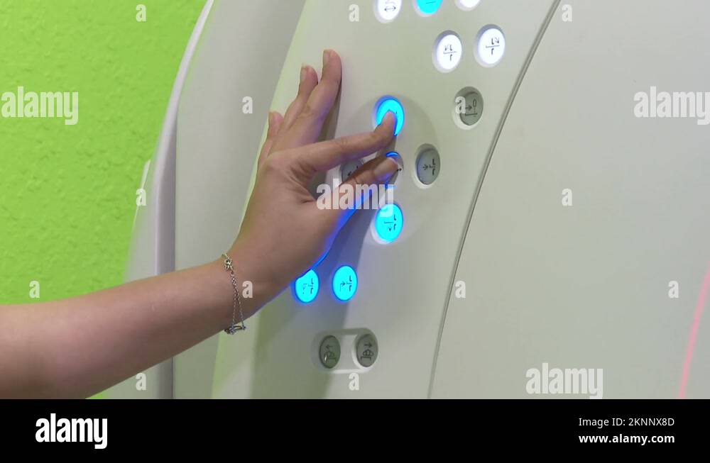 Pressing button on digital console panel on automatic mri tomography ...