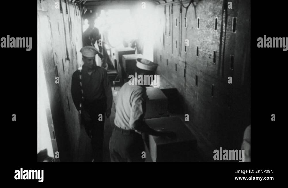 1960s: Soldiers load boxes of medical kits onto truck. Men stand ...