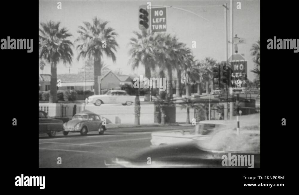 1950s: Shots of cars driving through intersection. Officer directing ...