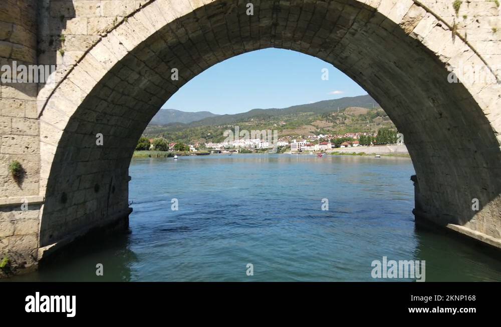 Floating on Drina river under arch of Mehmed Pasa Sokolovic bridge ...