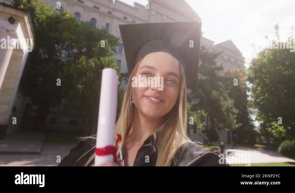 Excited great looking lady graduate she using the camera to make a ...
