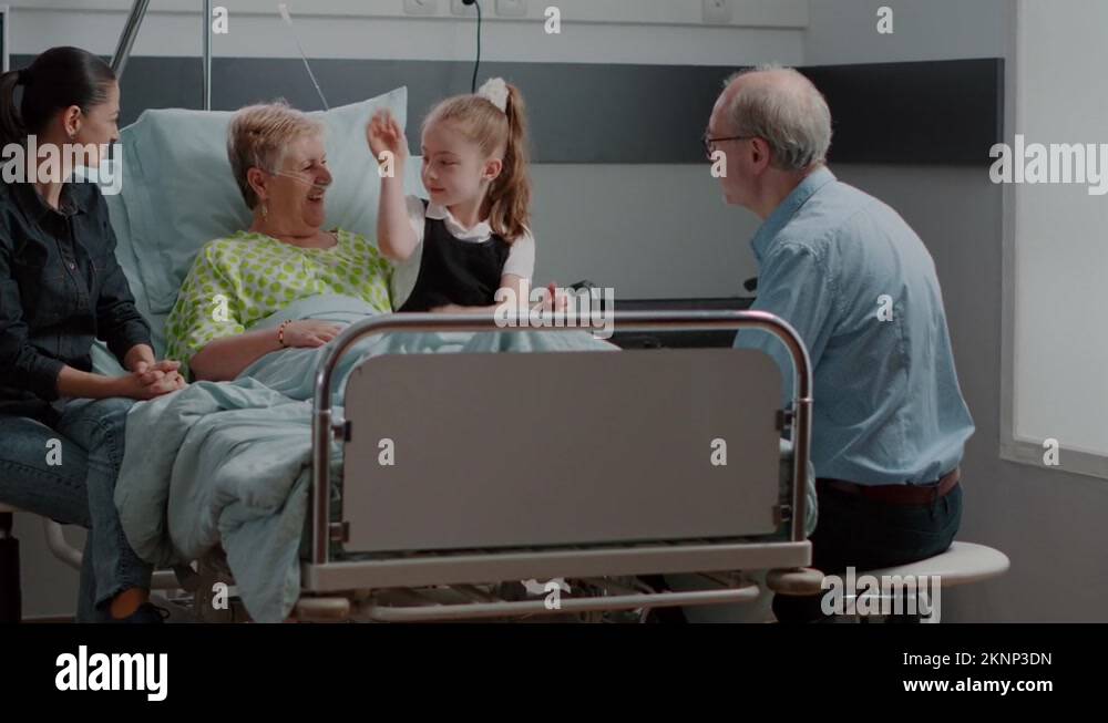 Kid hugging sick grandma at family visit in hospital ward Stock Video ...