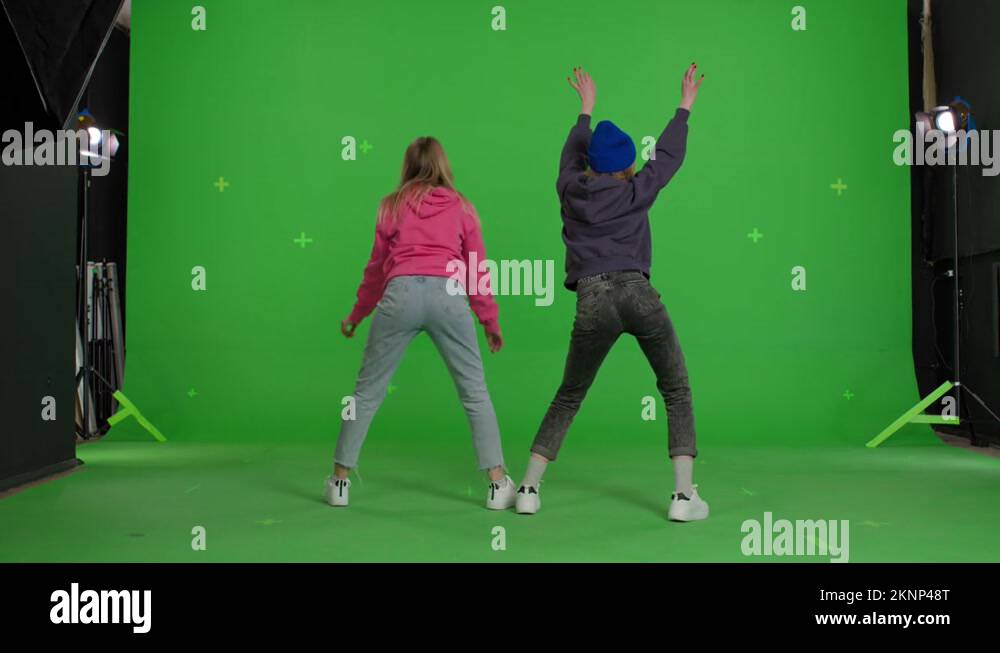 Two girls dancing over green screen background Stock Video Footage - Alamy