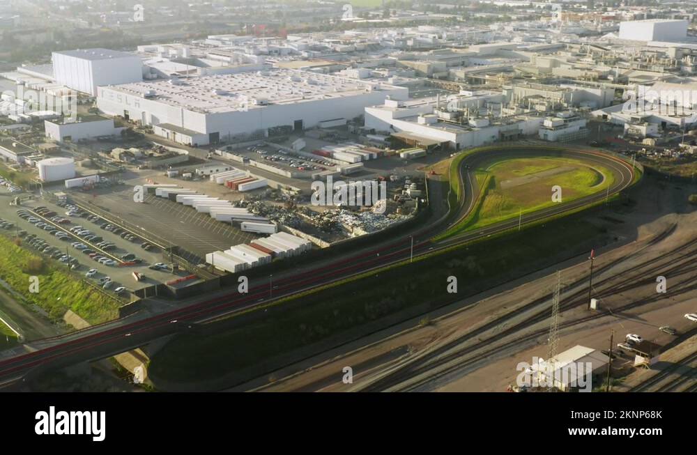 4K aerial footage of race track with brand new car driving to test, EV ...