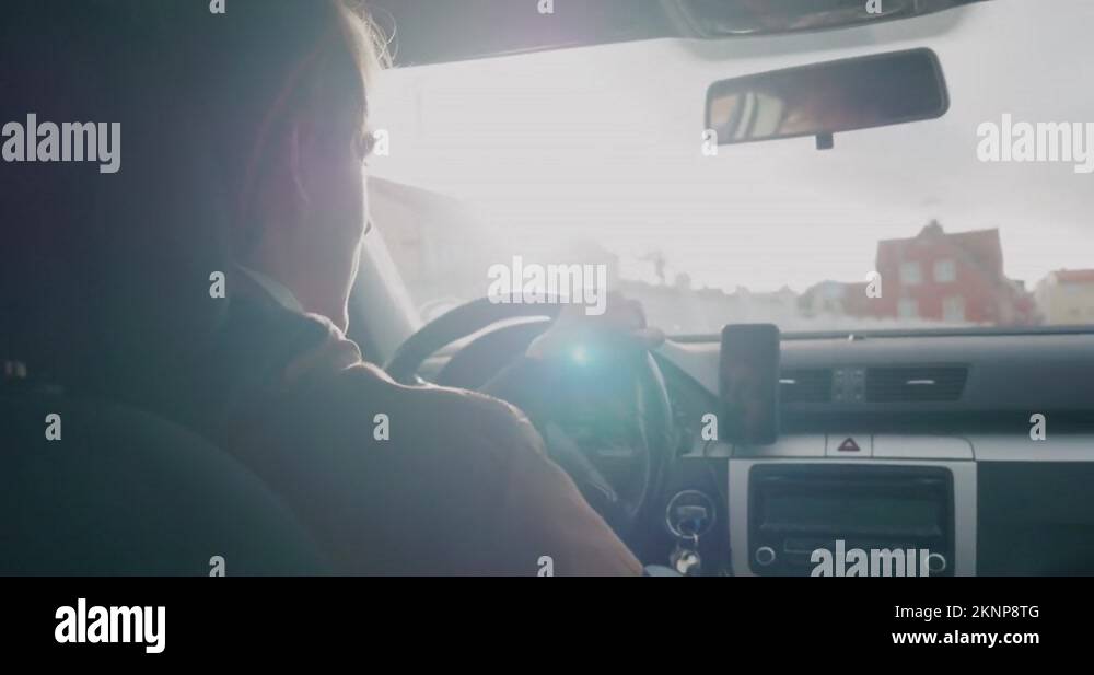 Young Tall Guy Drives a Car With The Sunlight Blocking Vision ...