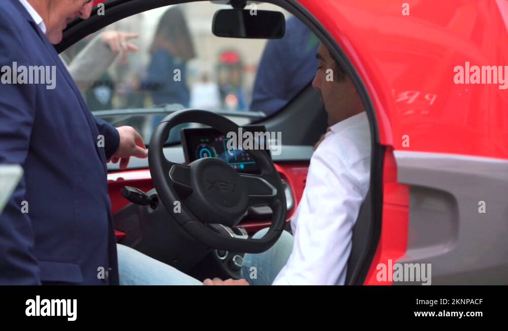 The staff is introducing new energy electric vehicles to passersby ...