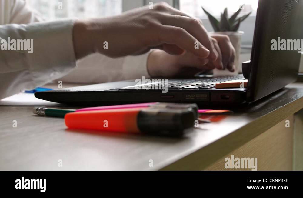 Desktop. male hands are typing on a laptop keyboard. writing materials ...