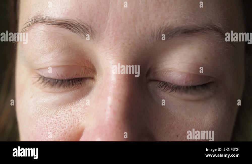 female eyes. closes and opens. without makeup, a little sleepy facial ...
