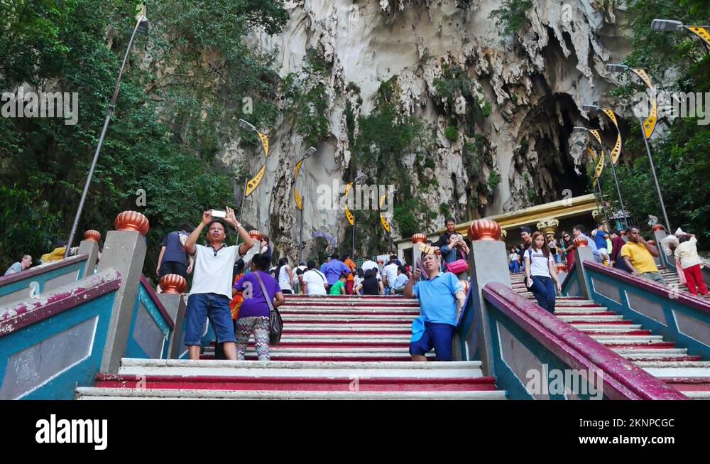 People can seen climbing on the stairs of entrance to the Batu Caves ...