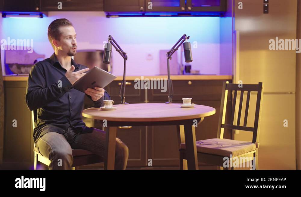 Host on live podcast introduce empty seat guest for round table ...