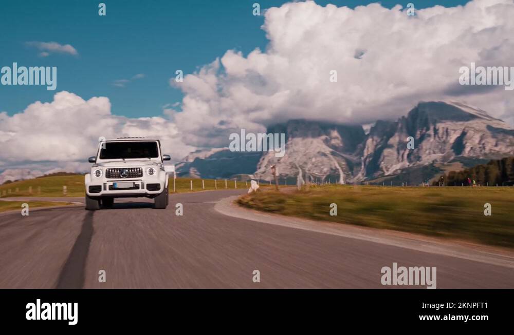 Rolling shot of Mercedes Benz G Class SUV luxury car driving on ...