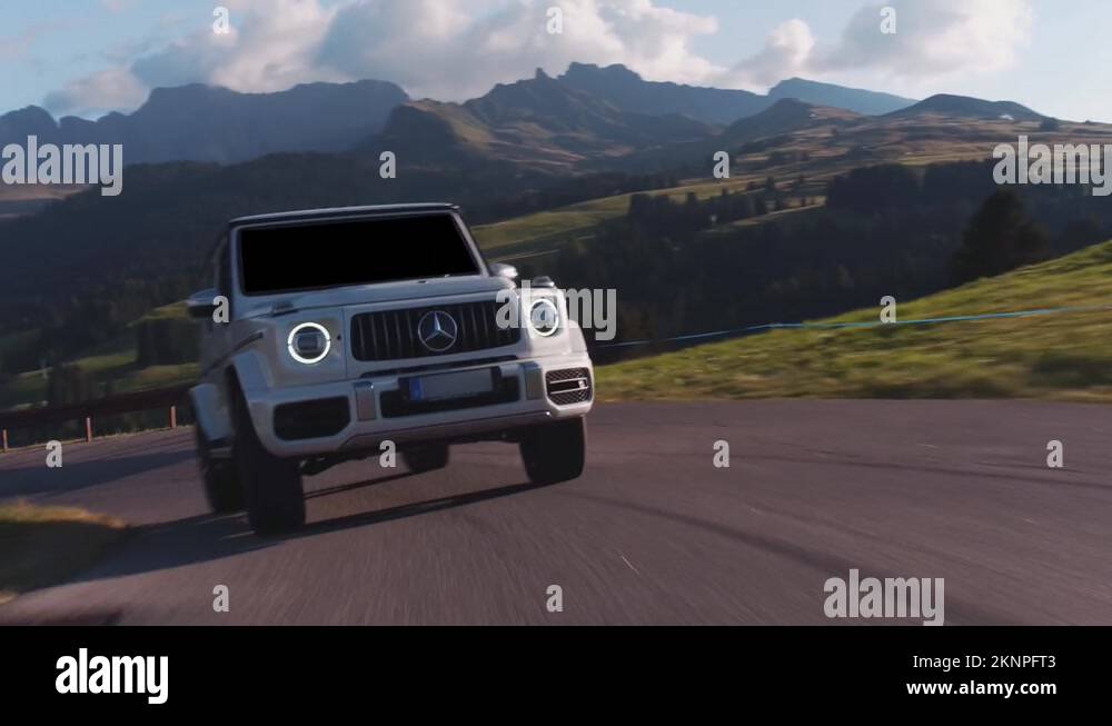 Rolling shot of Mercedes Benz G Class SUV luxury car driving on ...