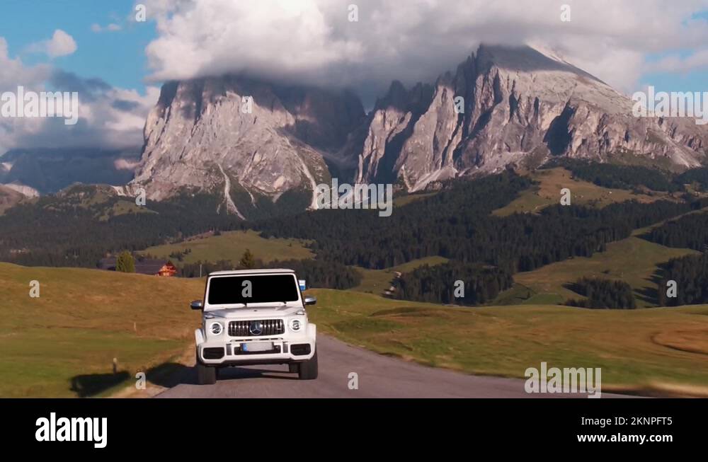 Rolling shot of Mercedes Benz G Class SUV luxury car driving on ...