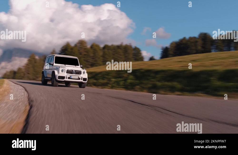Rolling shot of Mercedes Benz G Class SUV luxury car driving on ...