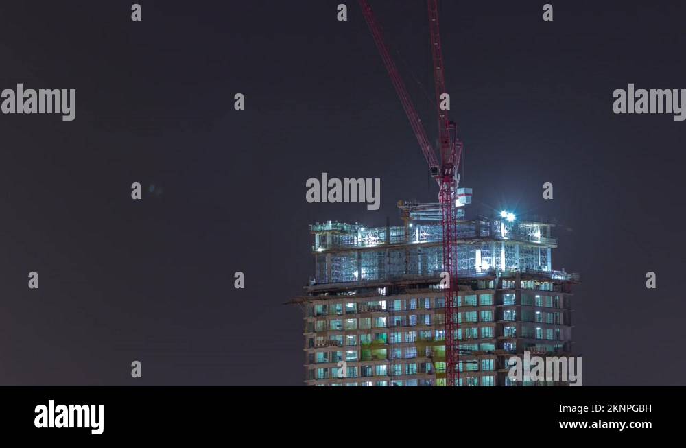 Tall building under construction and cranes night timelapse Stock Video ...