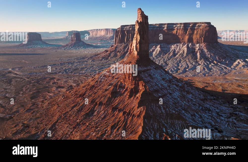 Cinematic red desert landscape with high rocky tower of sandstone cliff ...