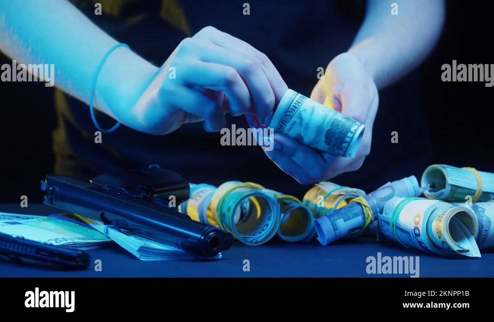 Putting money in a bundle close-up, cash. Euro and dollar banknotes ...