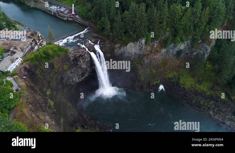 Cinematic aerial of Snoqualmie Falls and the Salish Lodge for tourists ...