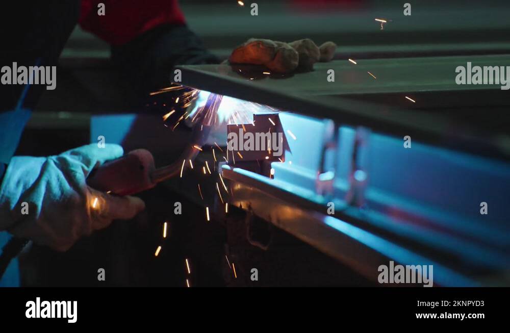 blacksmith working welding the steel plate in the factory spark flying ...