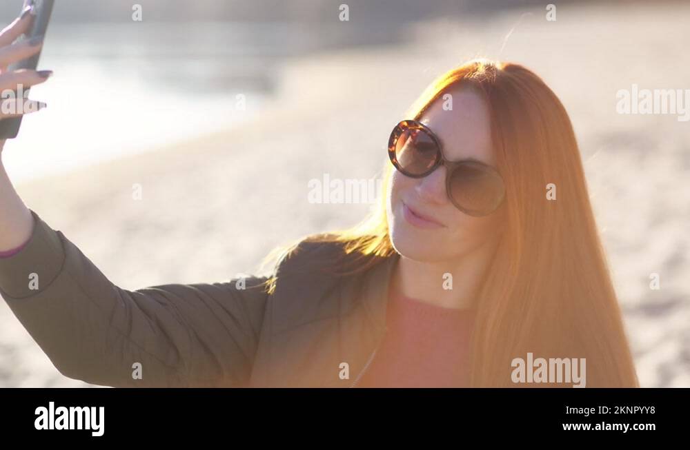 Woman makes self-portraits on spring sunny sandy beach background Stock ...
