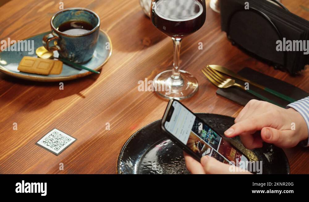 Scanning QR code in restaurant. Woman using qr code with smartphone ...