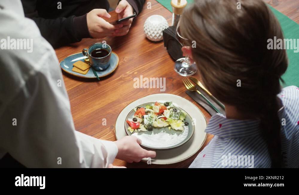 Scanning QR code in restaurant. Woman eating salad, using qr code with ...