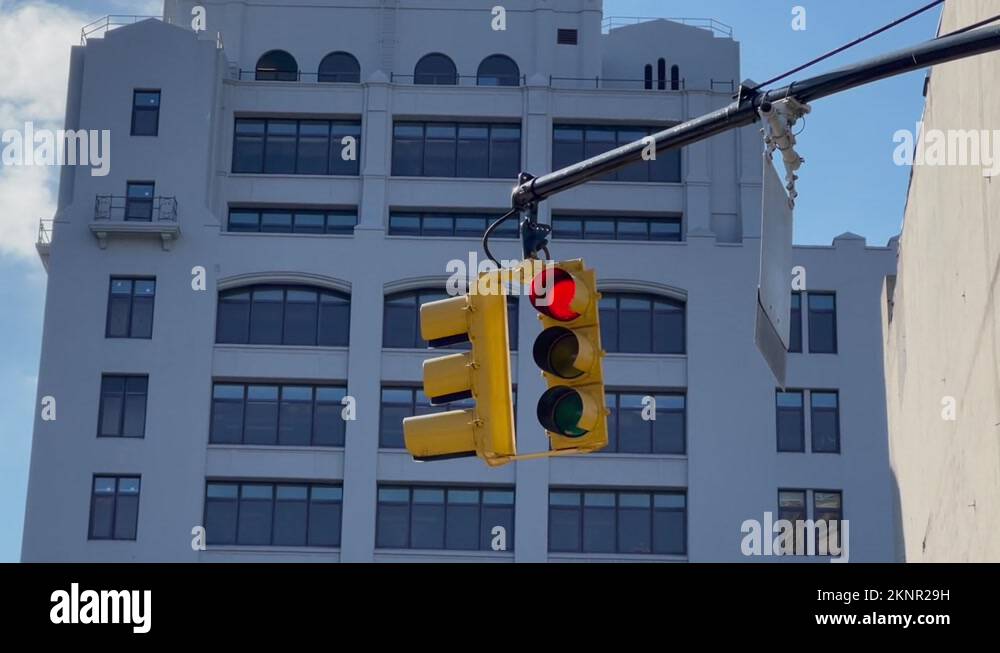 A yellow traffic light hangs at intersection in New York, USA. Red stop ...