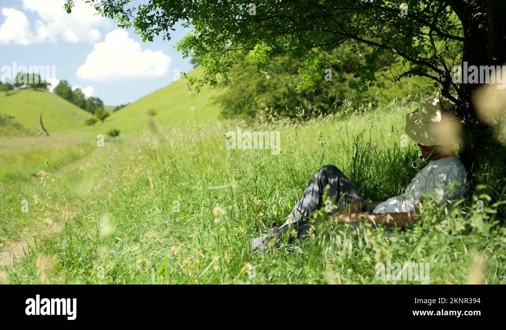 Man sleeping in the shadow of a tree Stock Video Footage - Alamy