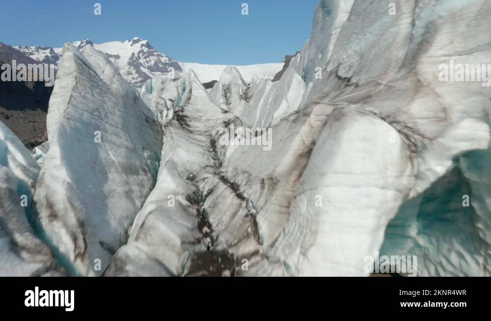 Revealing mass of ice of glacier in valley. Jagged white ice with ...
