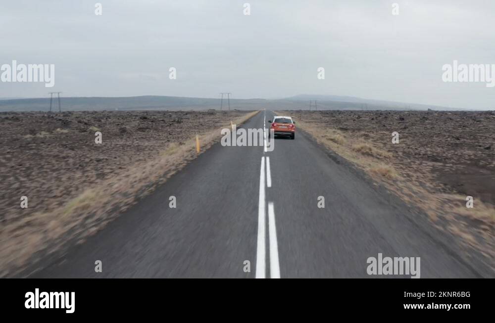 Forwards tracking of SUV car driving on road and passing with another ...