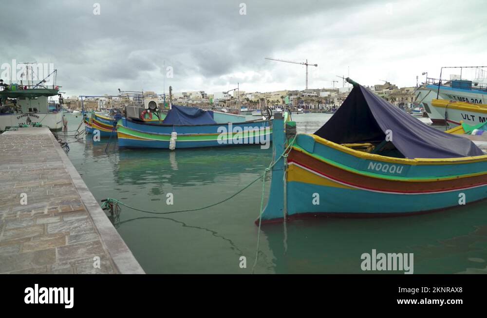 Traditional Maltese Fishing Boats Rocking on Surface of Water in Stock ...
