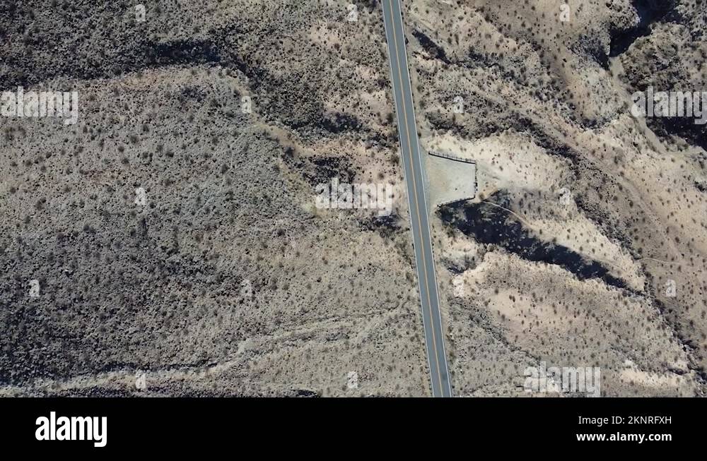 Empty highway road with concrete stop in California desert, aerial top ...