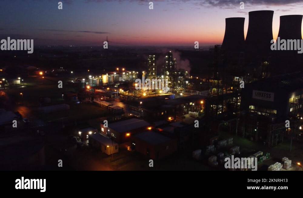 Illuminated aerial night view above industrial pipeline chemical ...
